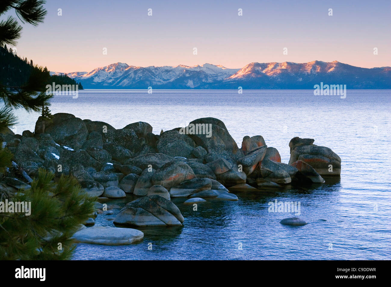 Rock formations in a lake with mountains in the background, Lake Tahoe ...