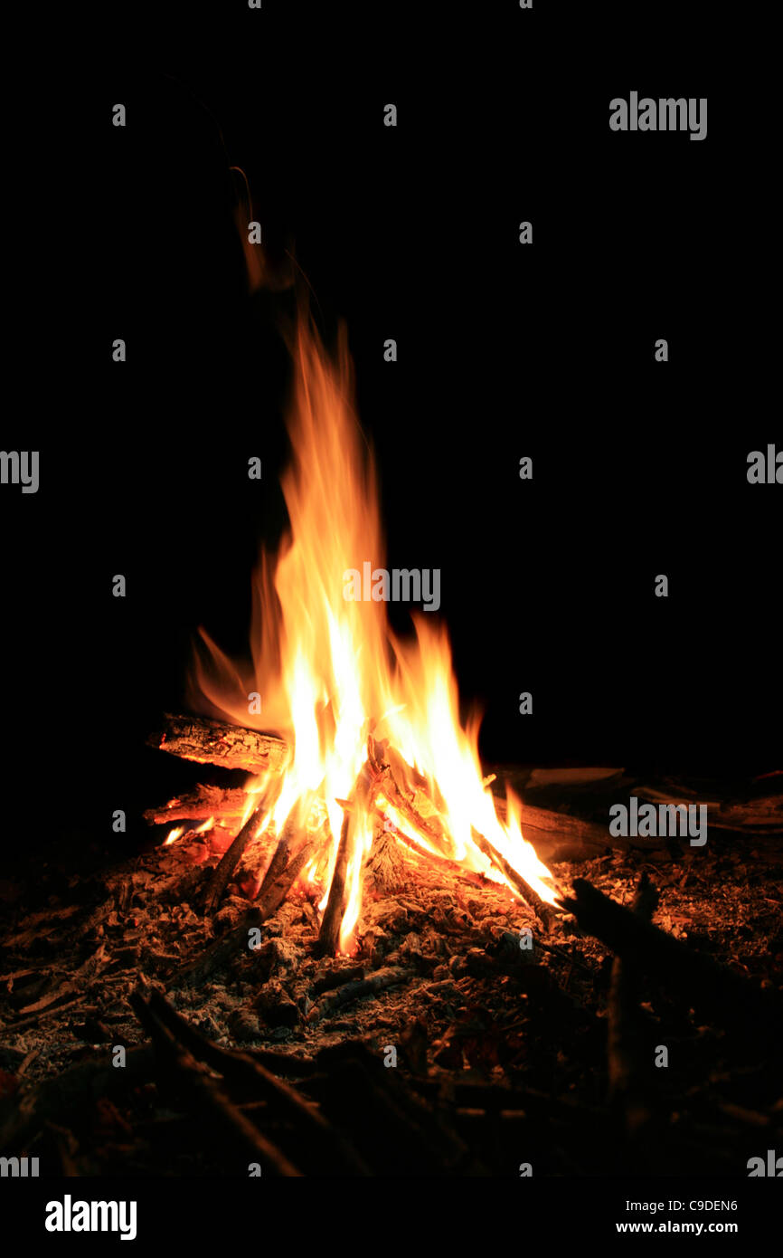 small campfire at night with black background Stock Photo - Alamy