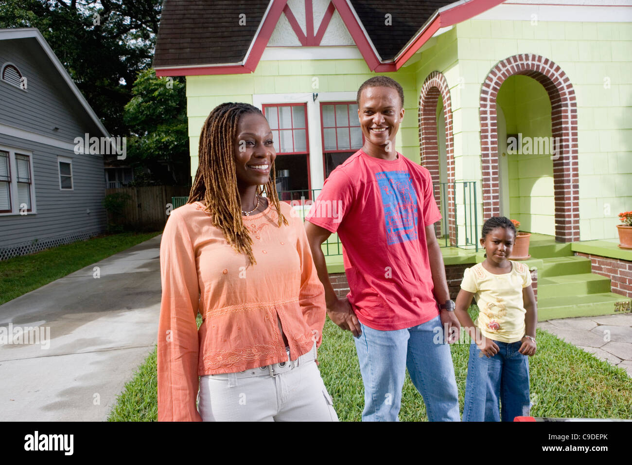 Portrait of family standing outside house Stock Photo - Alamy