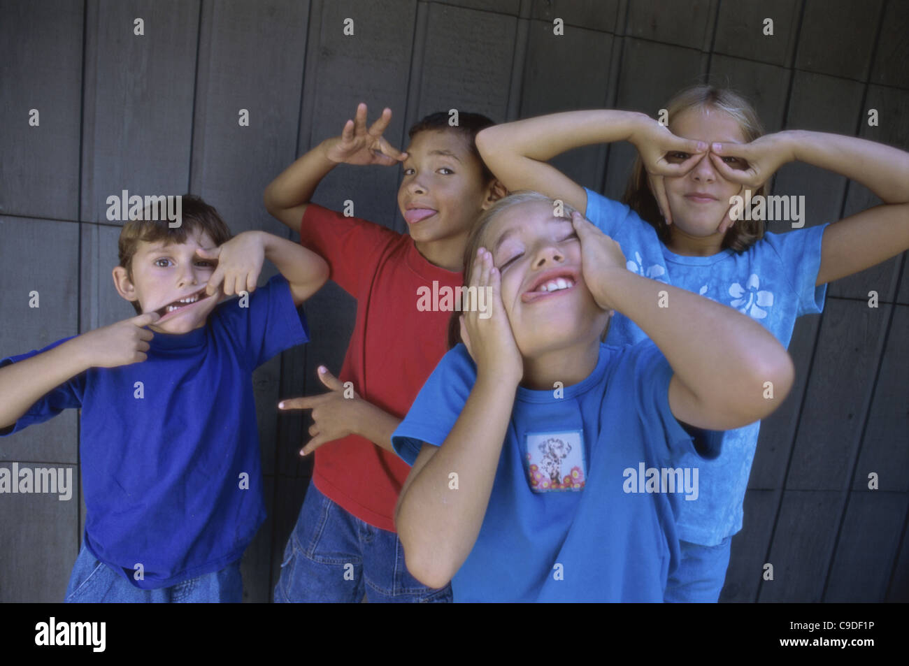 Portrait of a group of children making faces Stock Photo - Alamy