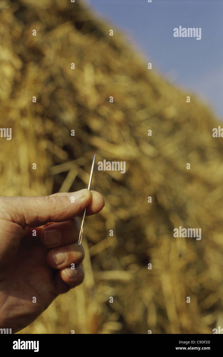 Close-up of a person holding a needle Stock Photo - Alamy