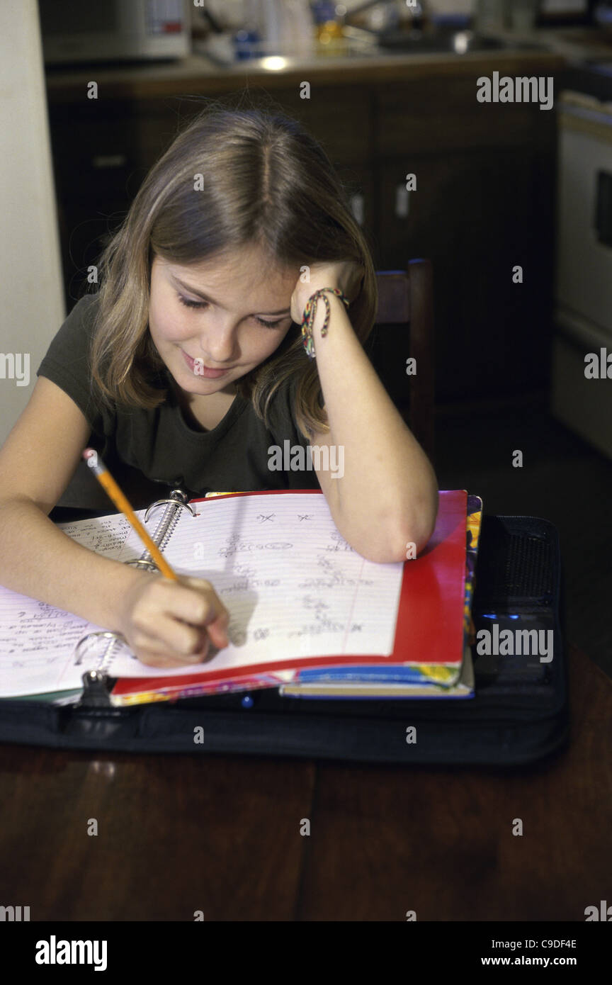 Girl writing in a book Stock Photo - Alamy