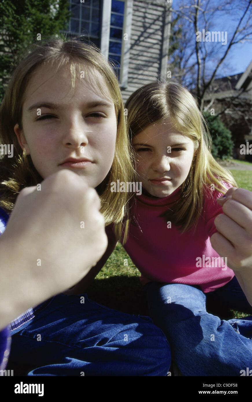 Portrait of two teenage girls showing fists Stock Photo - Alamy