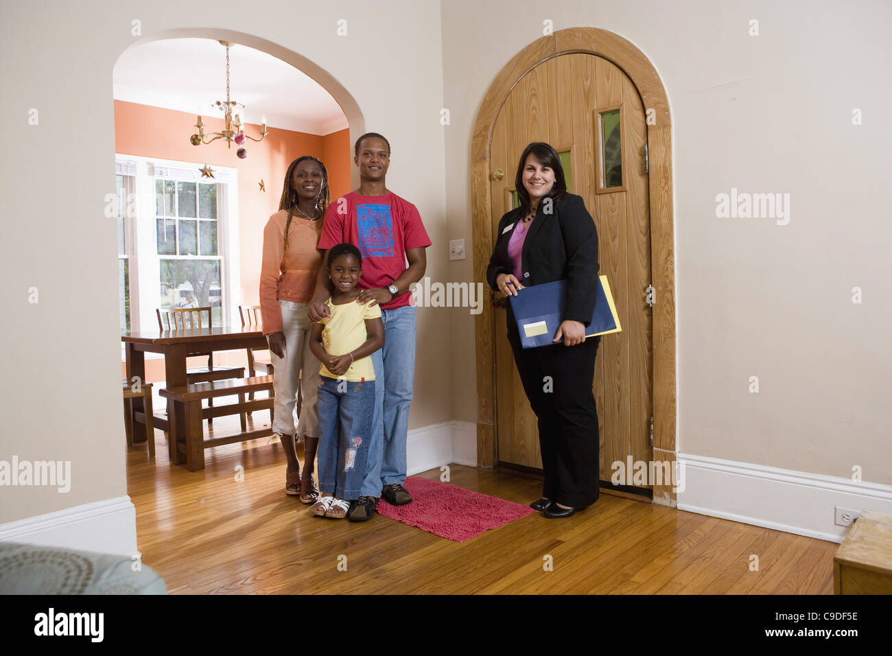 Portrait of family inside house with real estate broker Stock Photo - Alamy