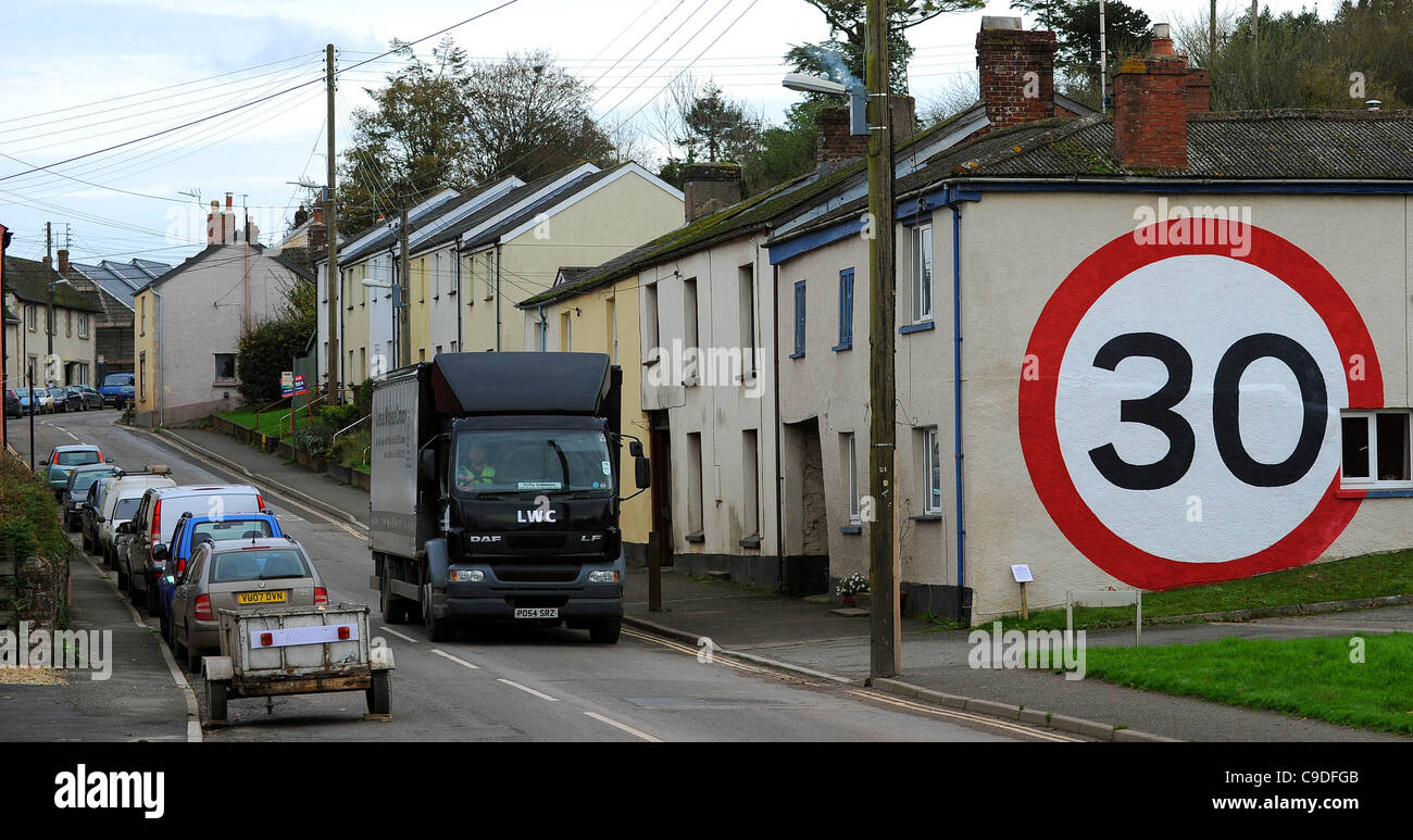 23.11.11. A giant painted 30mph road sign on the side of a house to ...