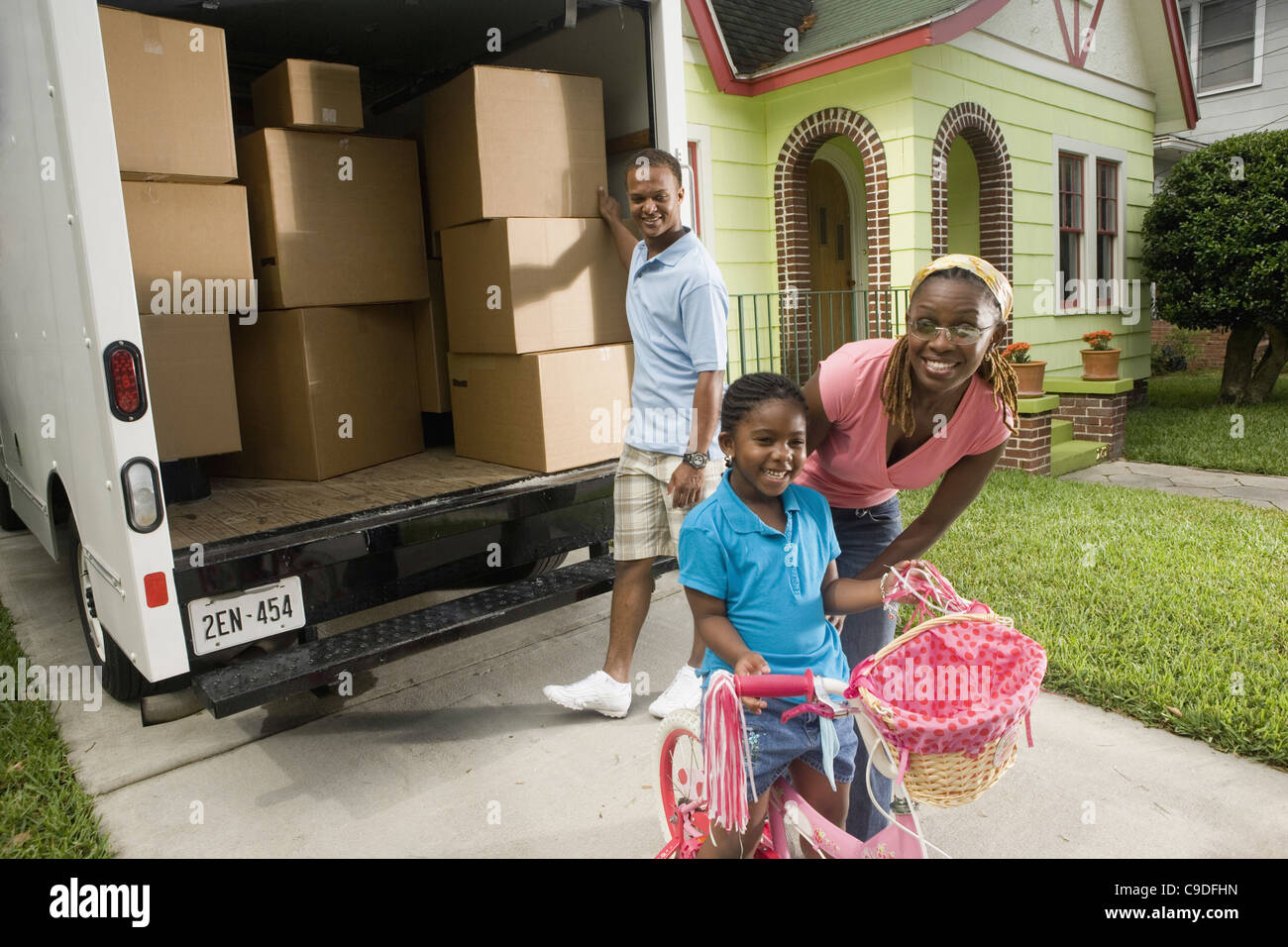 Portrait of family next to moving truck Stock Photo - Alamy