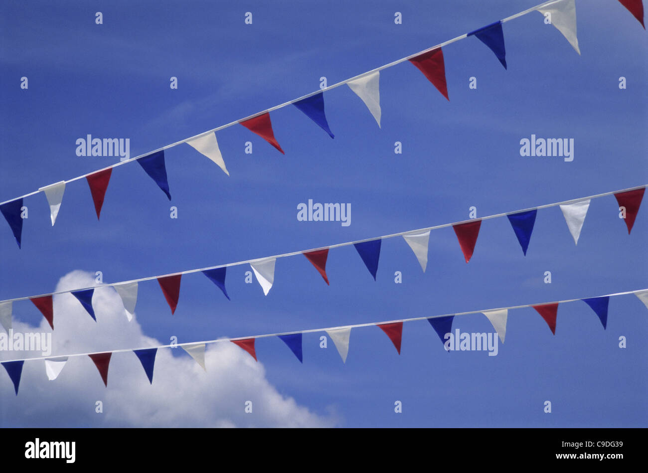 Flags on strings hanging overhead Stock Photo - Alamy