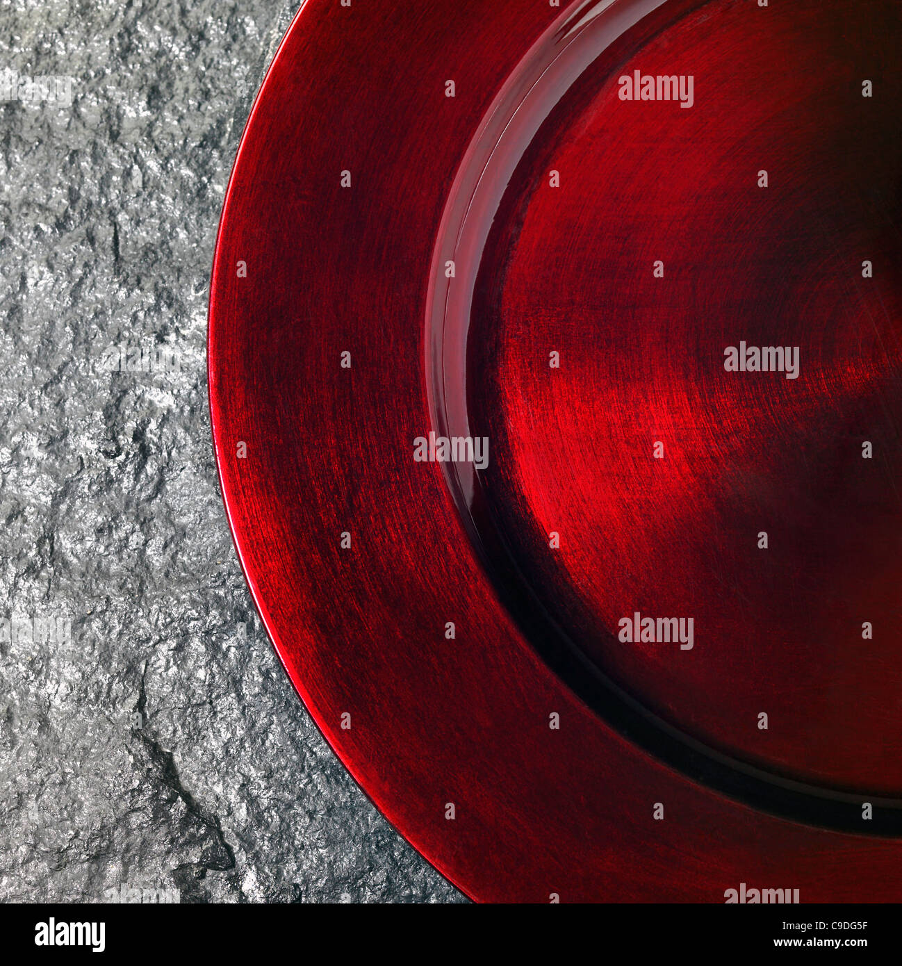 detail of a round red metal plate on rough grey stone surface Stock ...