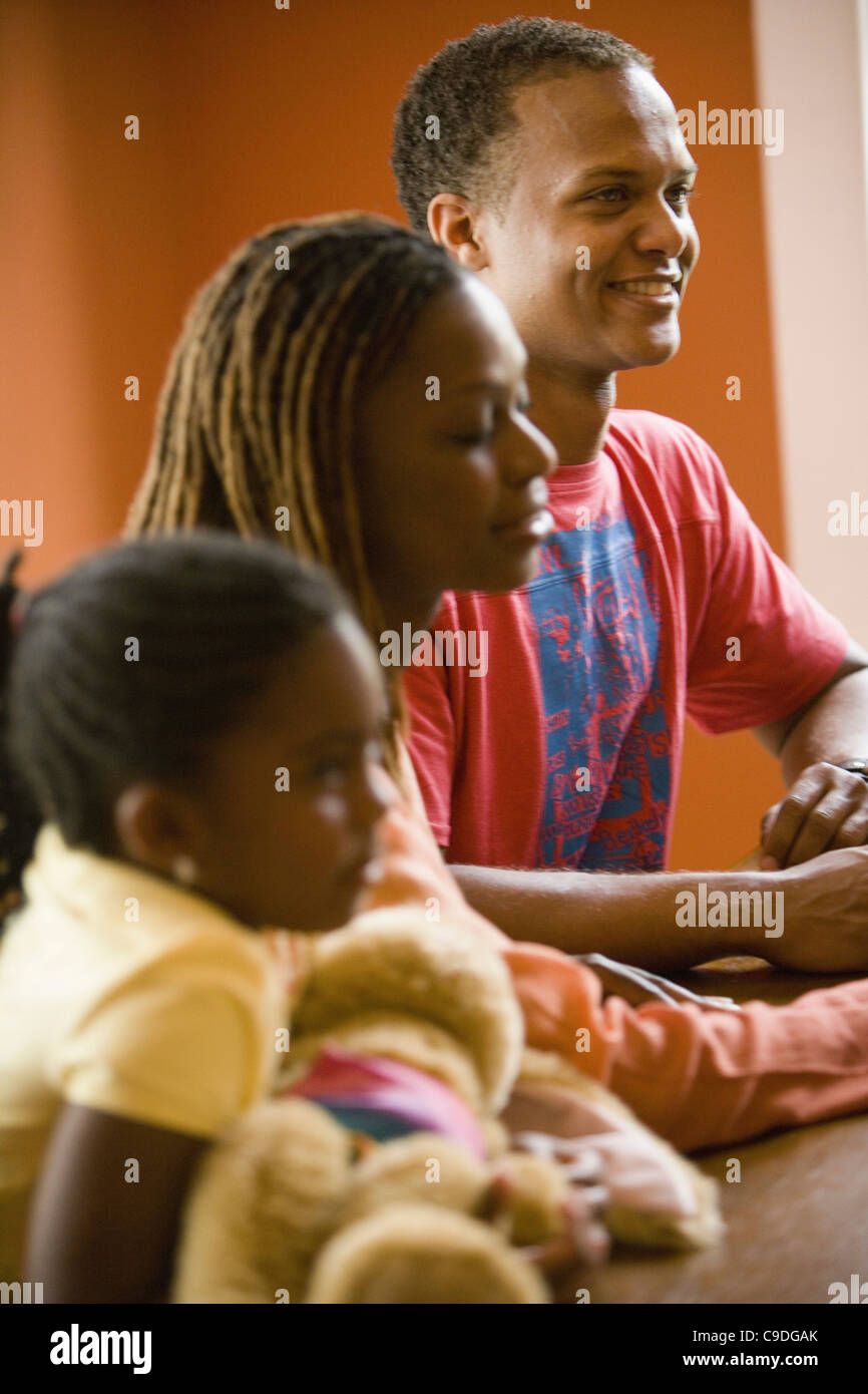 Family sitting inside a house Stock Photo - Alamy