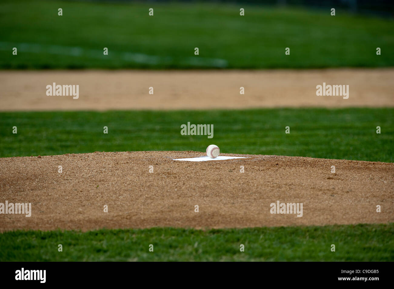 Pitcher mound with baseball Stock Photo - Alamy