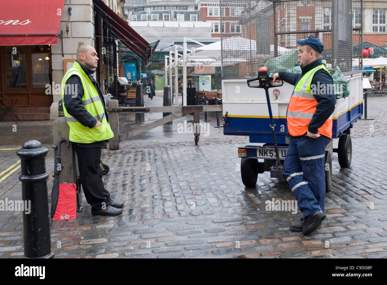 London Covent Garden Market two road sweepers day glow hi vis jackets ...