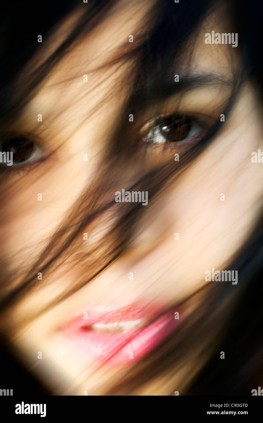 Portrait of a young woman staring Stock Photo - Alamy