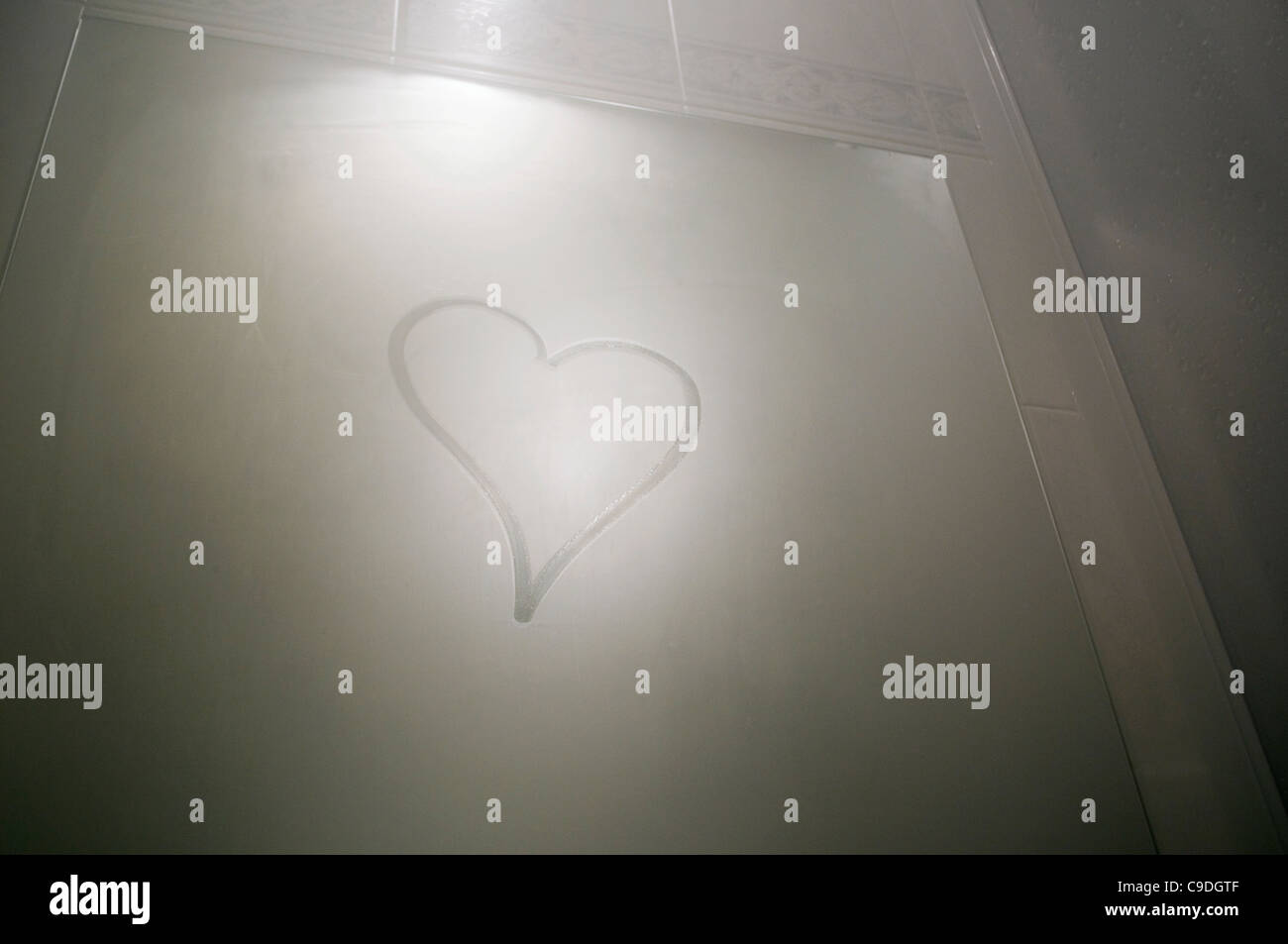 Heart shape on steamed mirror in bathroom Stock Photo - Alamy