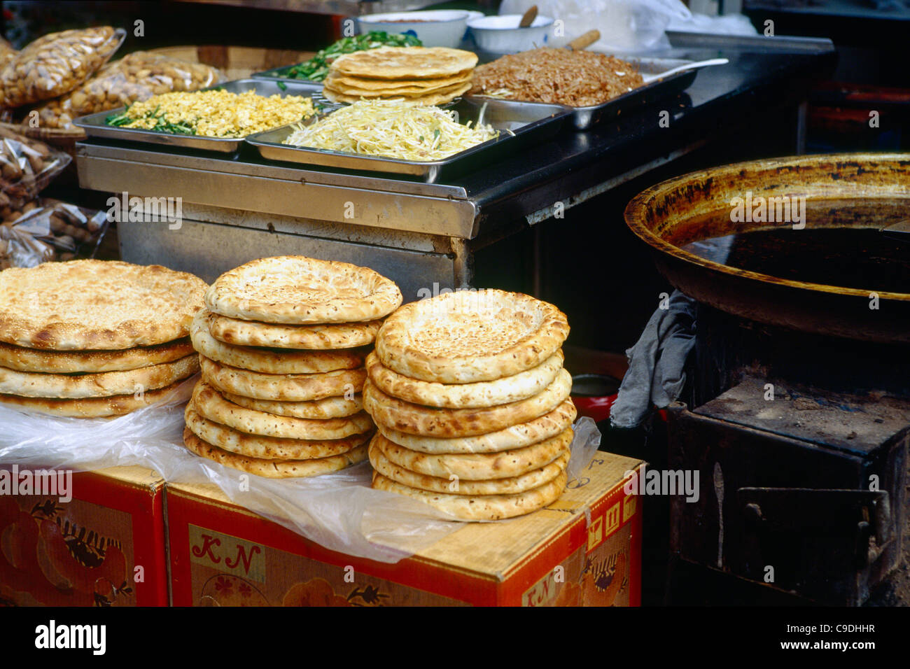 China, Xian, Stack of flat bread and toppings at outdoor food market at ...