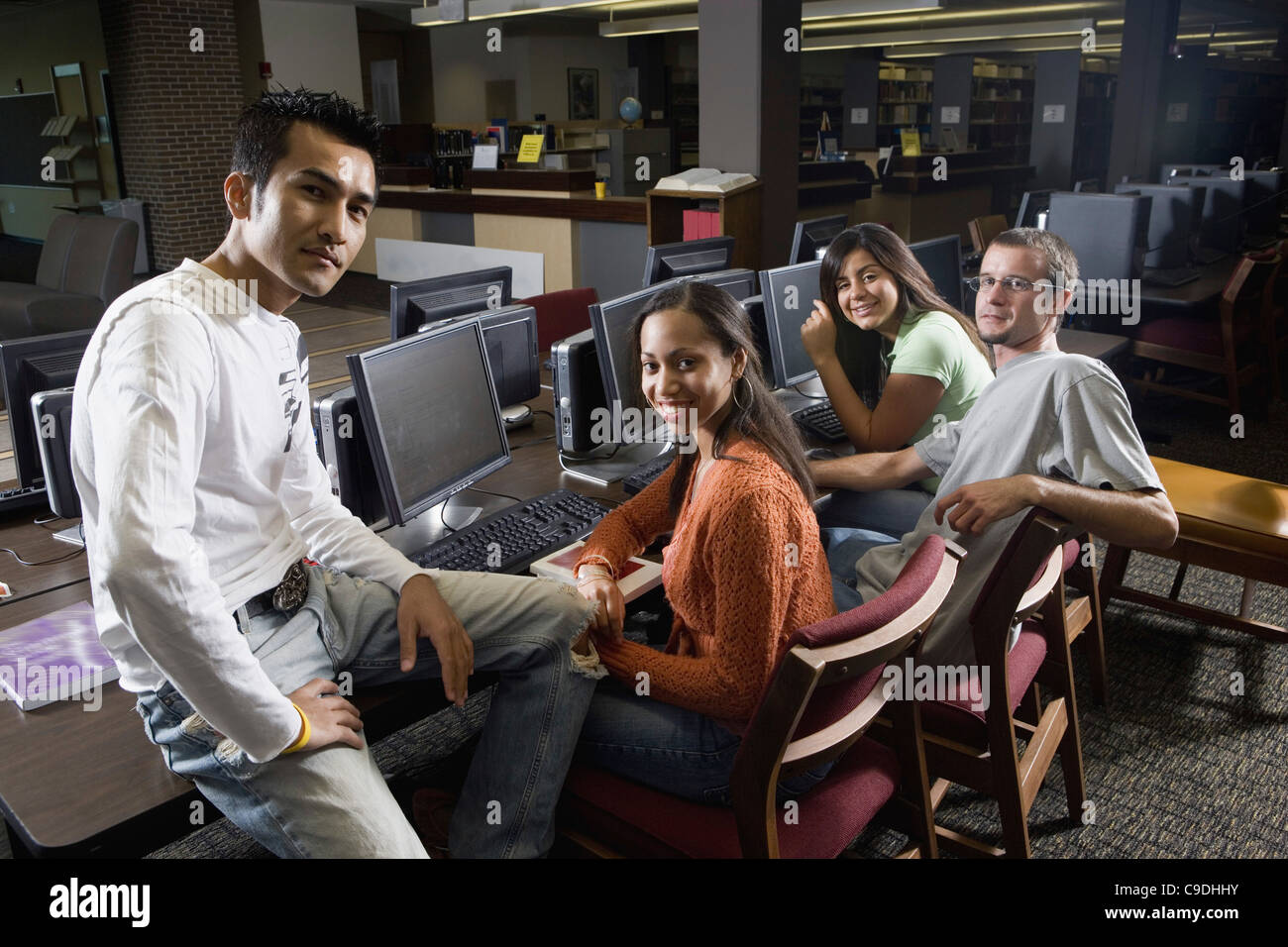 Portrait of students sitting together while using computers in the ...