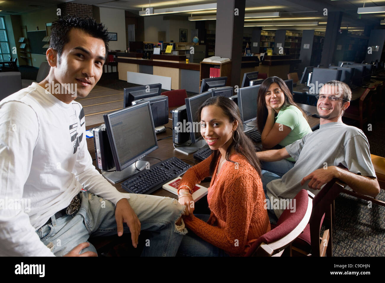 Portrait of students sitting together while using computers in the ...