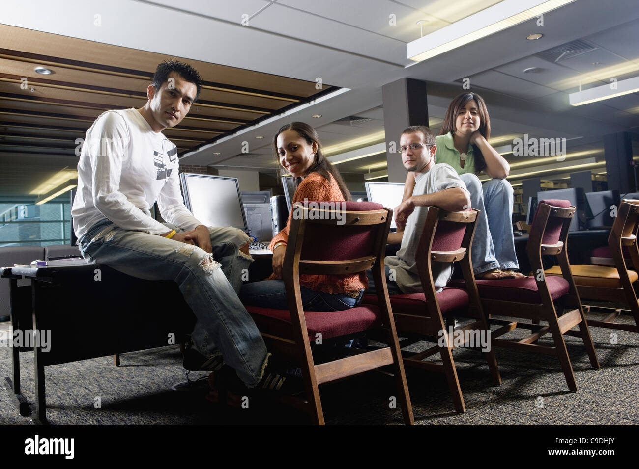 Portrait of students sitting together while using computers in the ...