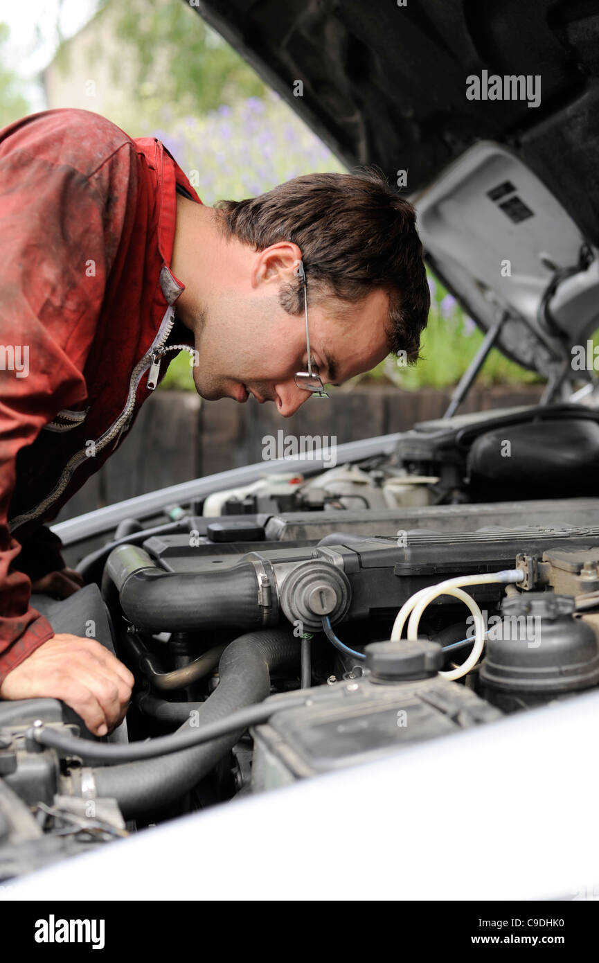 young mechanist checking a car engine Stock Photo - Alamy