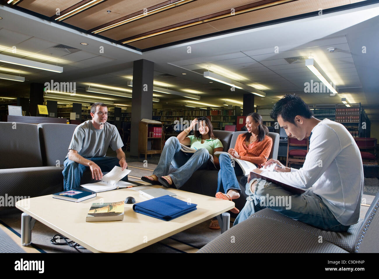 Students in library sitting on sofas studying Stock Photo - Alamy
