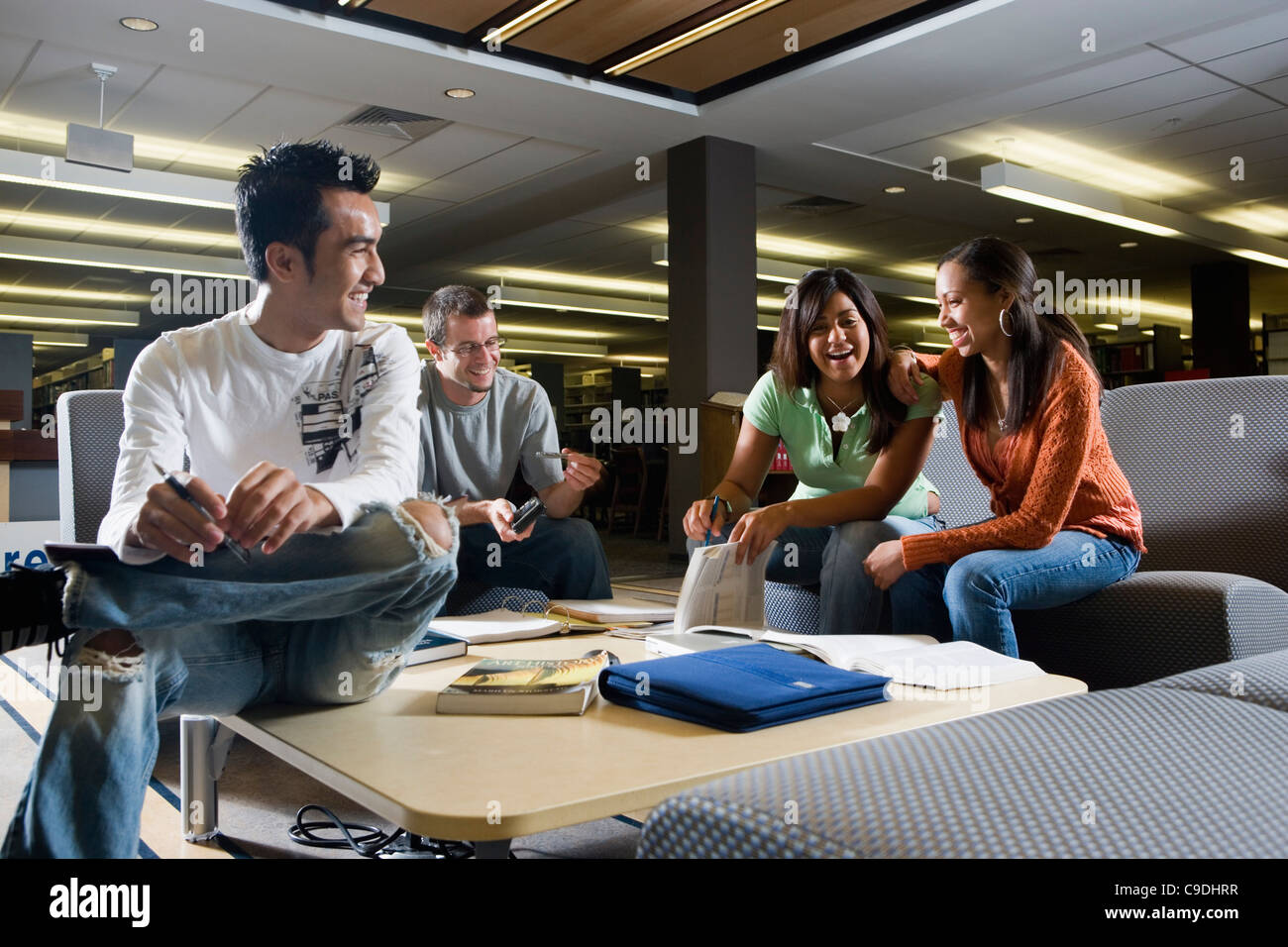 Students in library sitting on sofas studying Stock Photo - Alamy