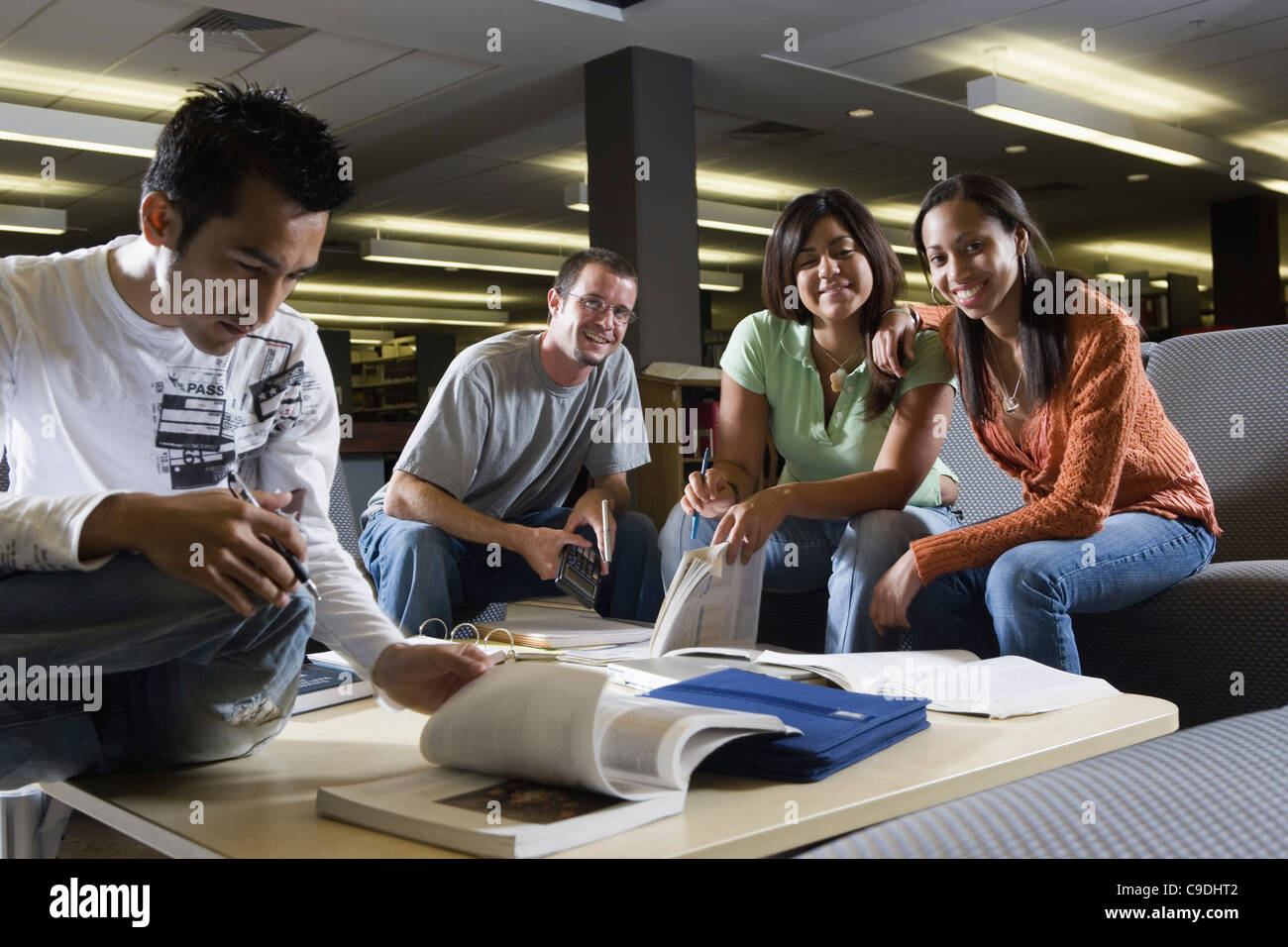 Students in library sitting on sofas studying Stock Photo - Alamy