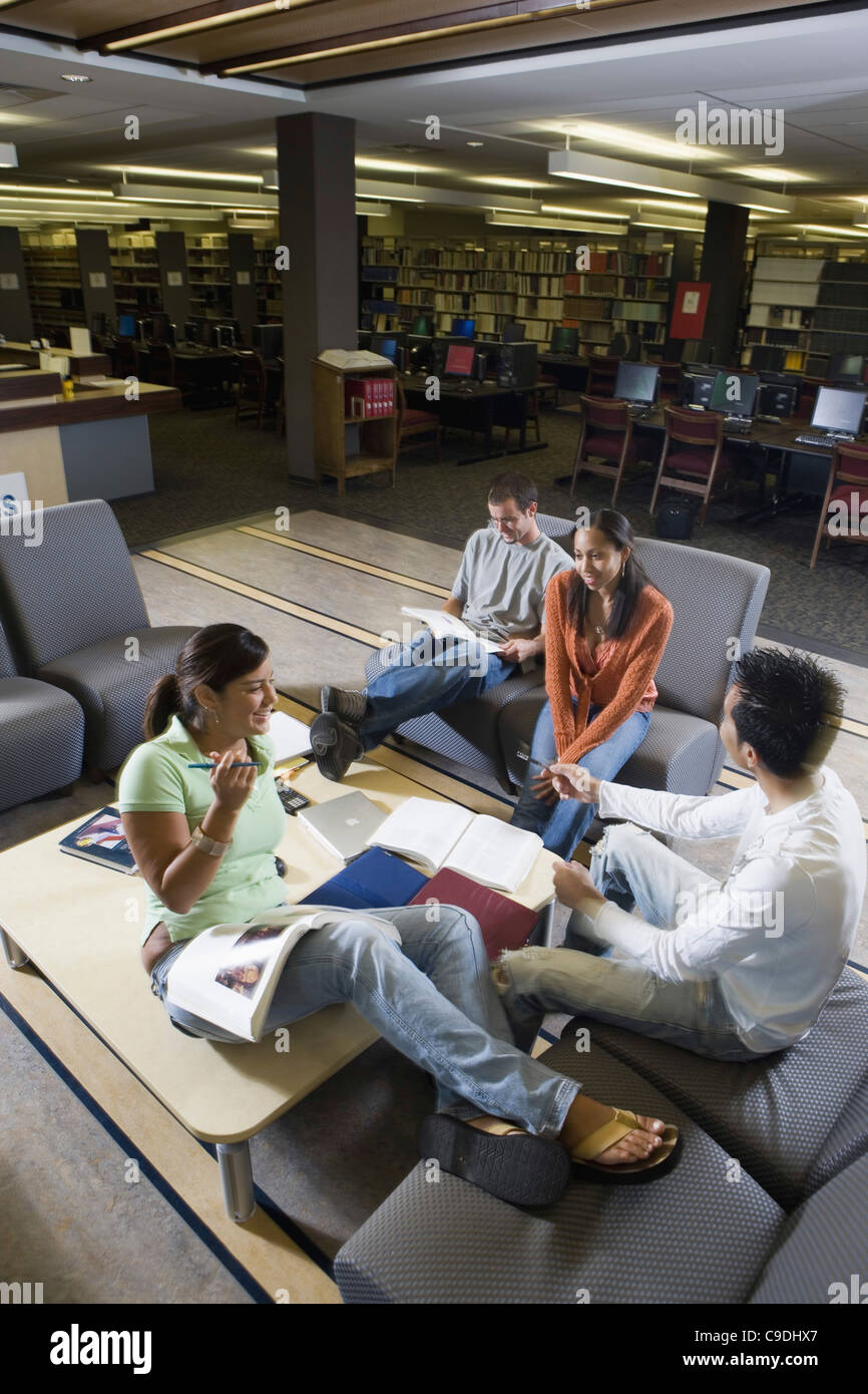 Students in library sitting on sofas studying Stock Photo - Alamy