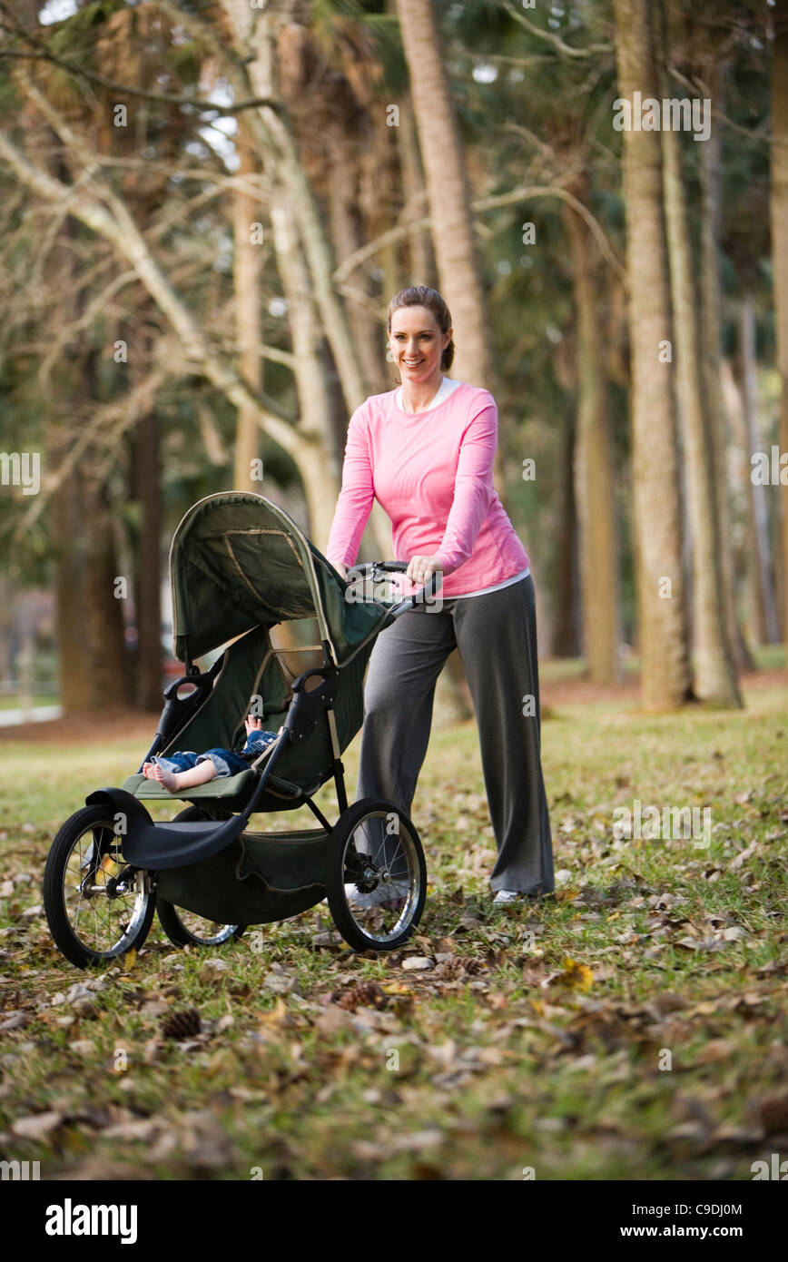 Portrait of a mother with baby in a stroller Stock Photo - Alamy