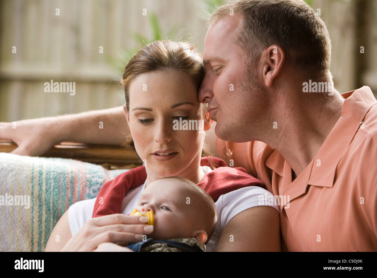 Portrait of loving parents with baby outdoors Stock Photo - Alamy