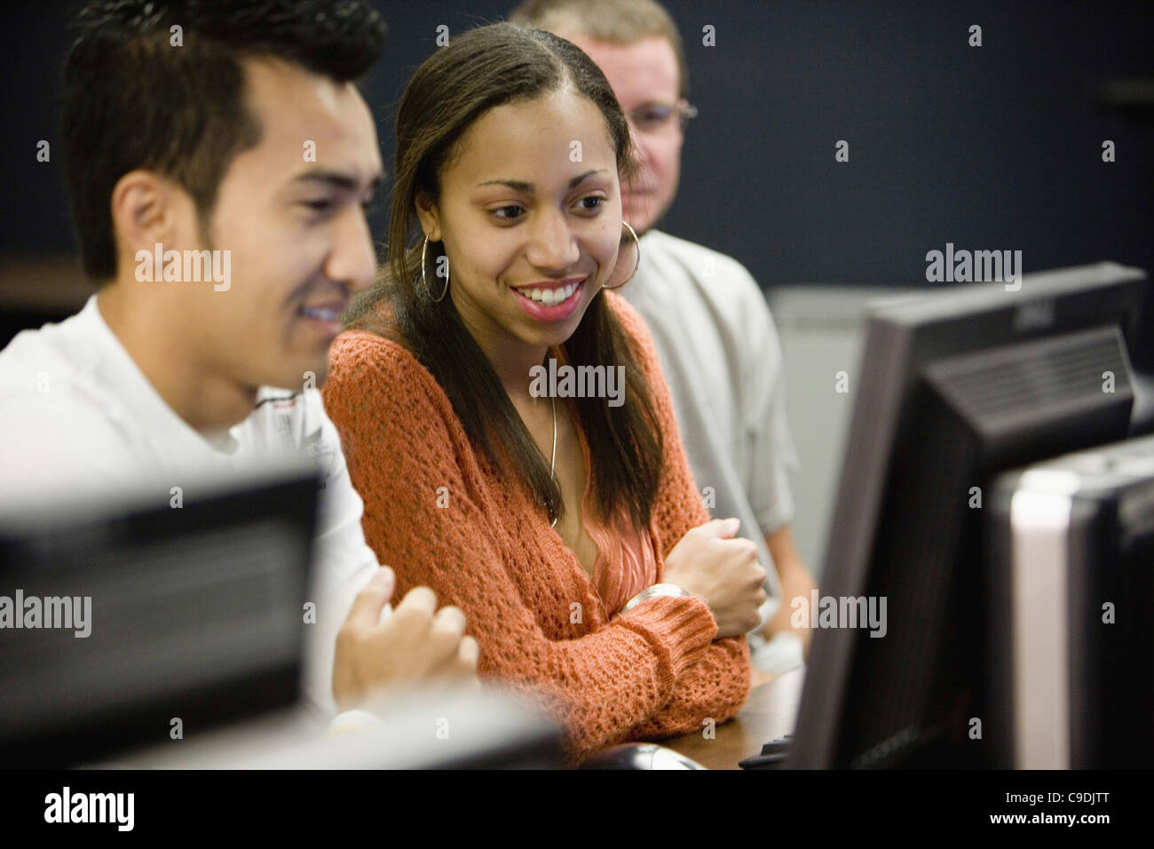 Three university students using computer Stock Photo - Alamy
