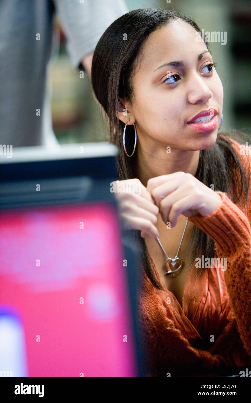 Student sitting in front of computer monitor Stock Photo - Alamy