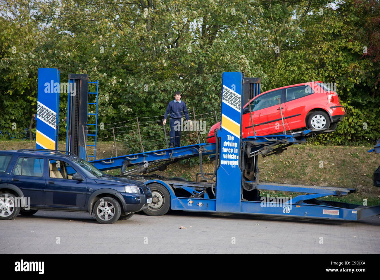 Loading vehicles onto a car transporter Stock Photo - Alamy