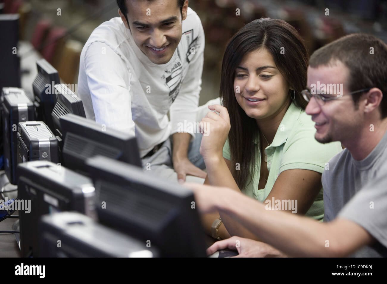 Three university students using computer Stock Photo - Alamy