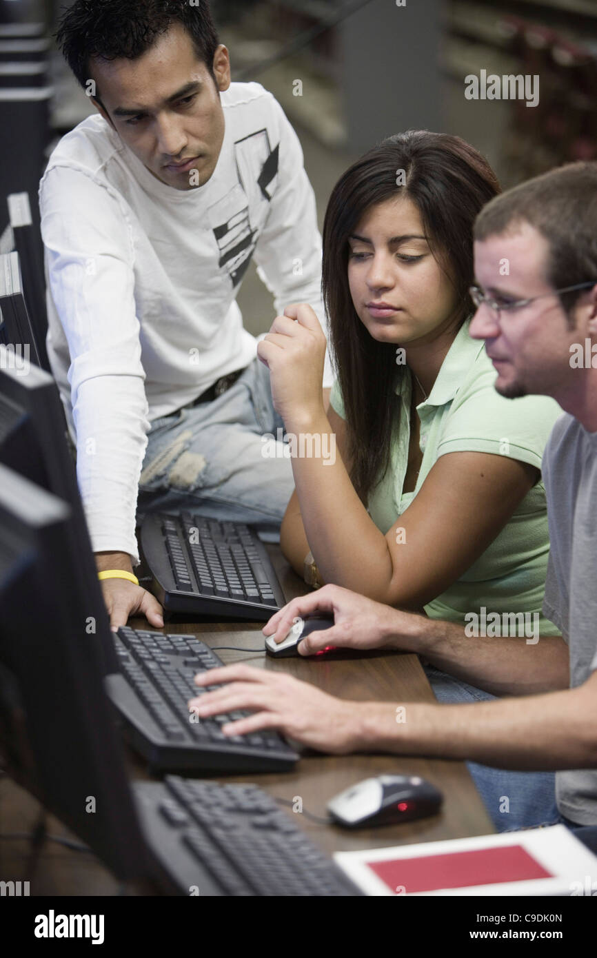 Three university students using computer Stock Photo - Alamy