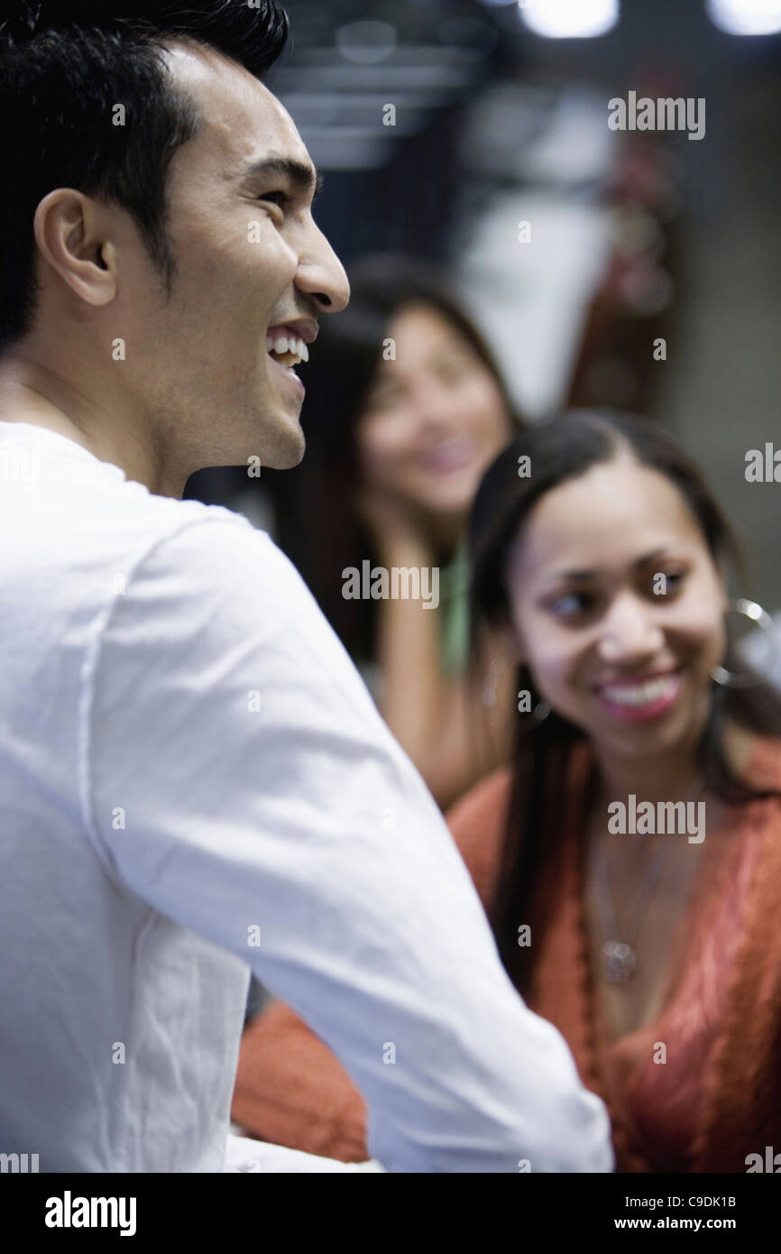 Side view of a young man with friends Stock Photo - Alamy