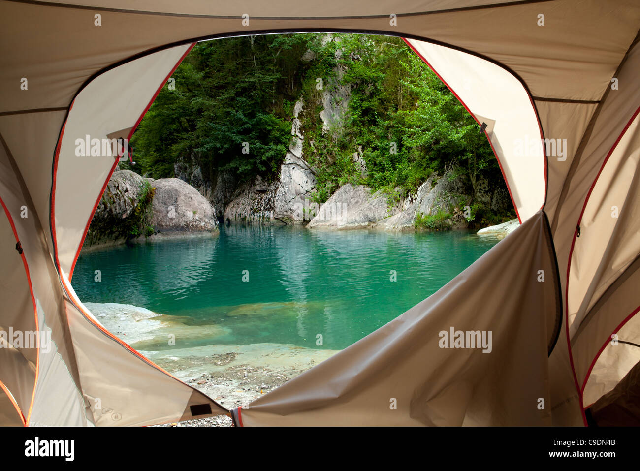 View looking out of door of sun-filled tent upon great outdoors Stock ...
