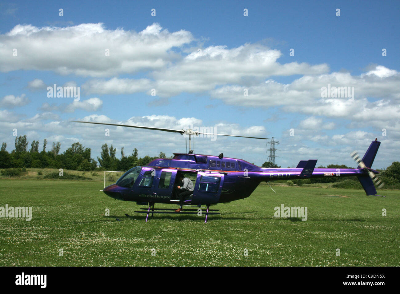 Helicopter landing in field Stock Photo - Alamy