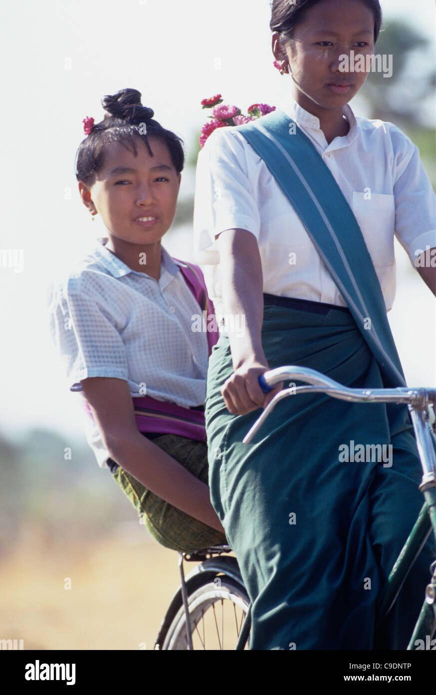 Young female students in uniform on bicycle, Magwe Division, Central ...