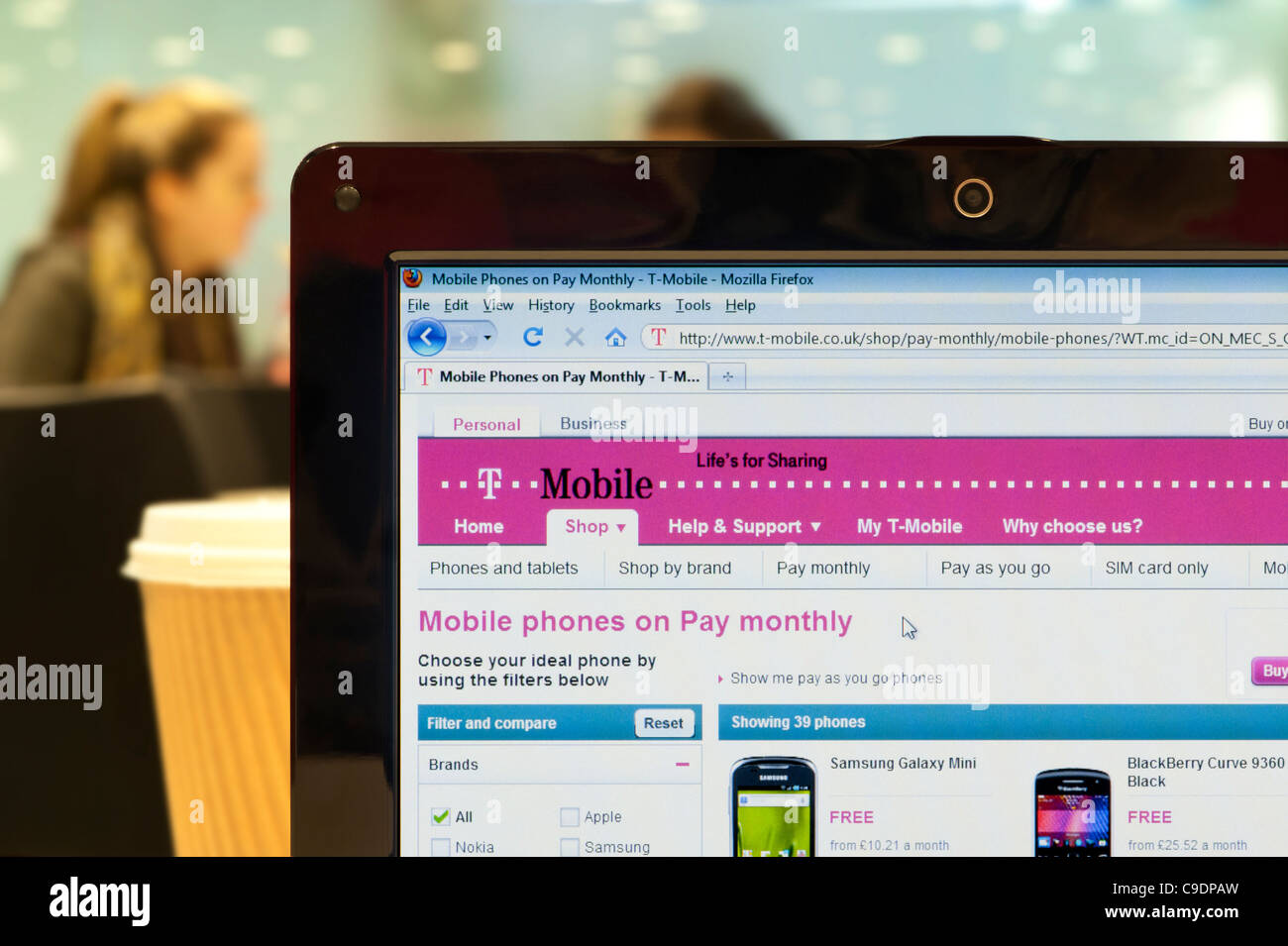 The T-Mobile website shot in a coffee shop environment (Editorial use ...