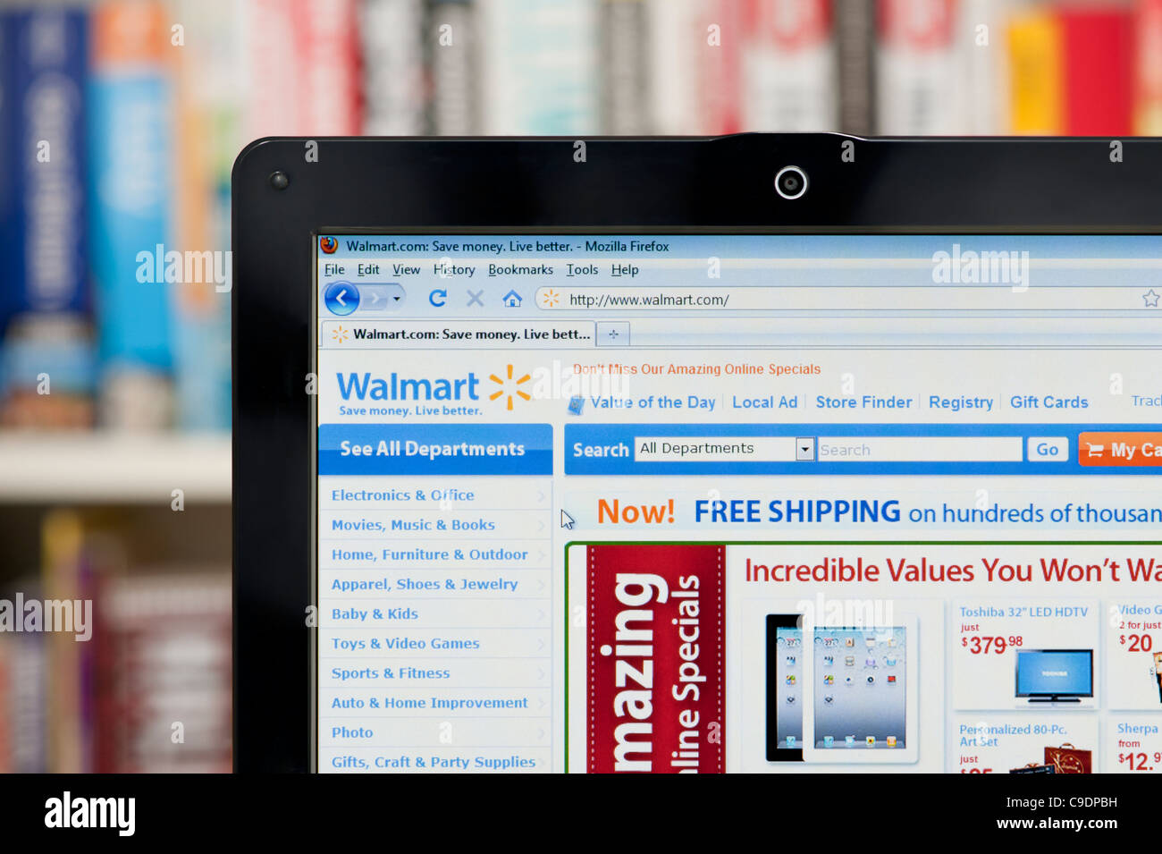 The Walmart website shot against a bookcase background (Editorial use ...