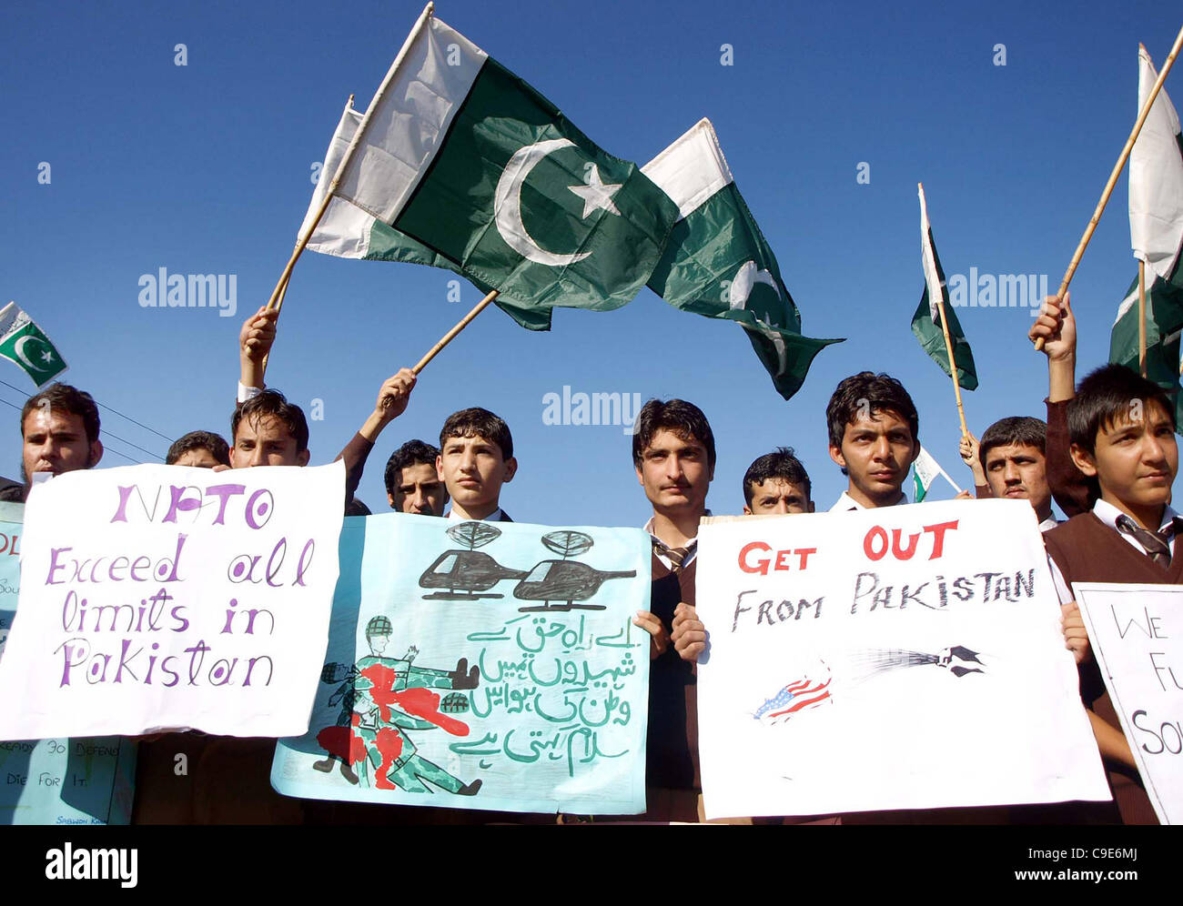 Students hold national flags and posters during rally in favor of Pak ...