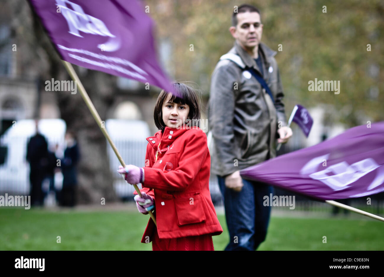 Girls play with trade union flags while speakers address crowd at the ...