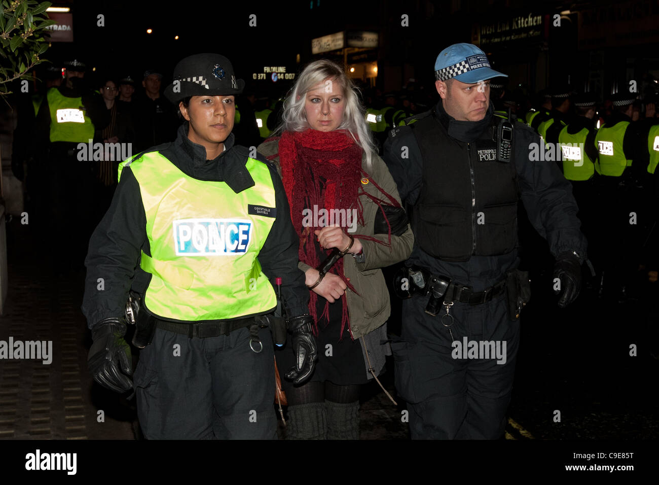 London, UK, 30/11/2011. Protester being led away under arrest after an ...