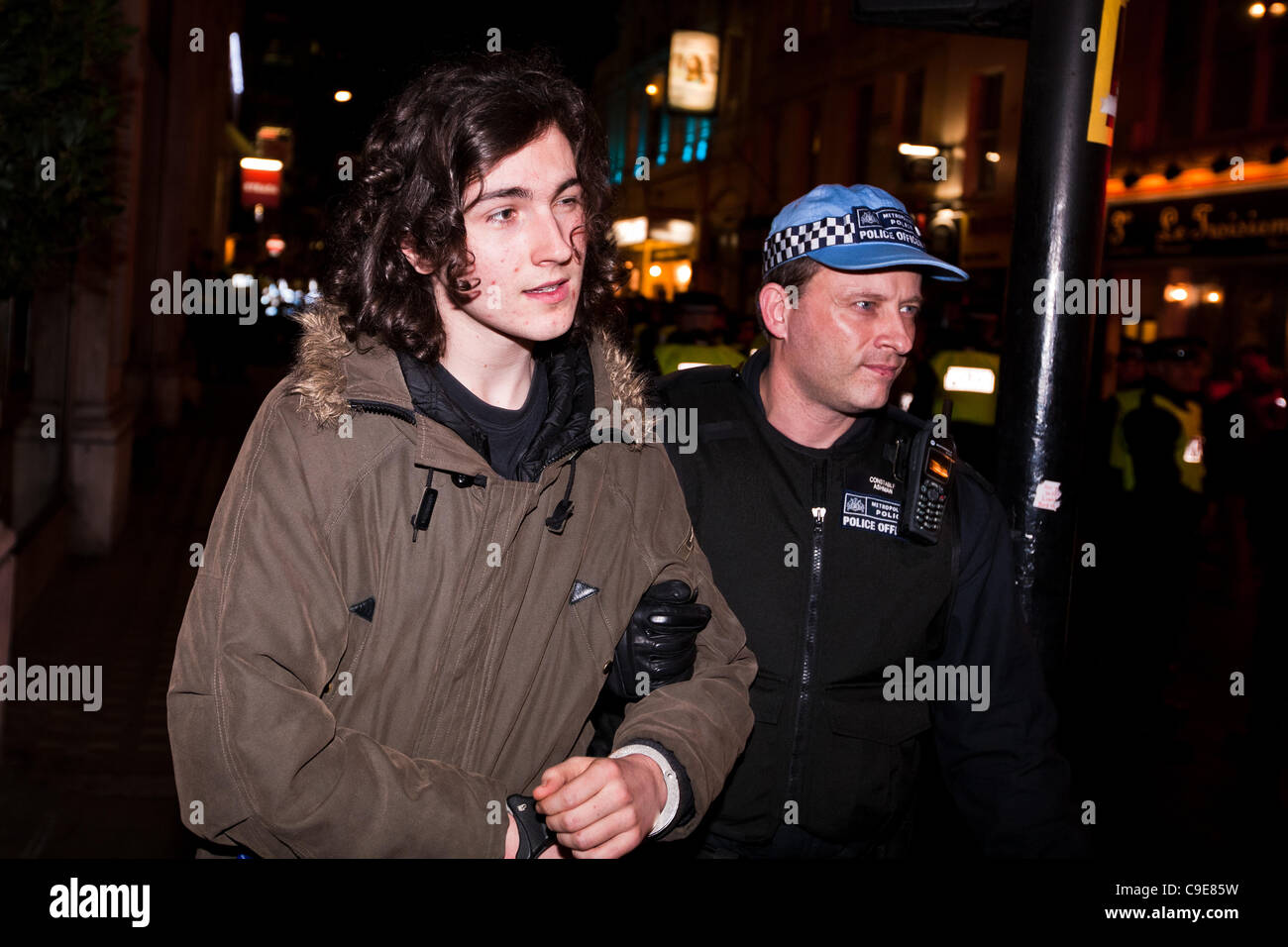 London, UK, 30/11/2011. Protester being led away under arrest after an ...