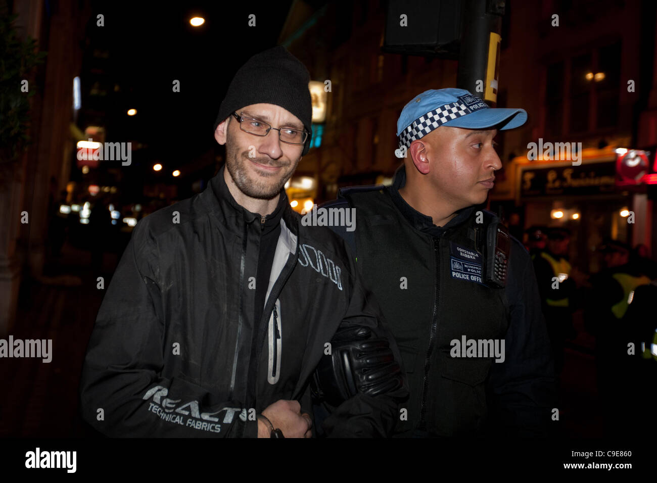 London, UK, 30/11/2011. Protester being led away under arrest after an ...