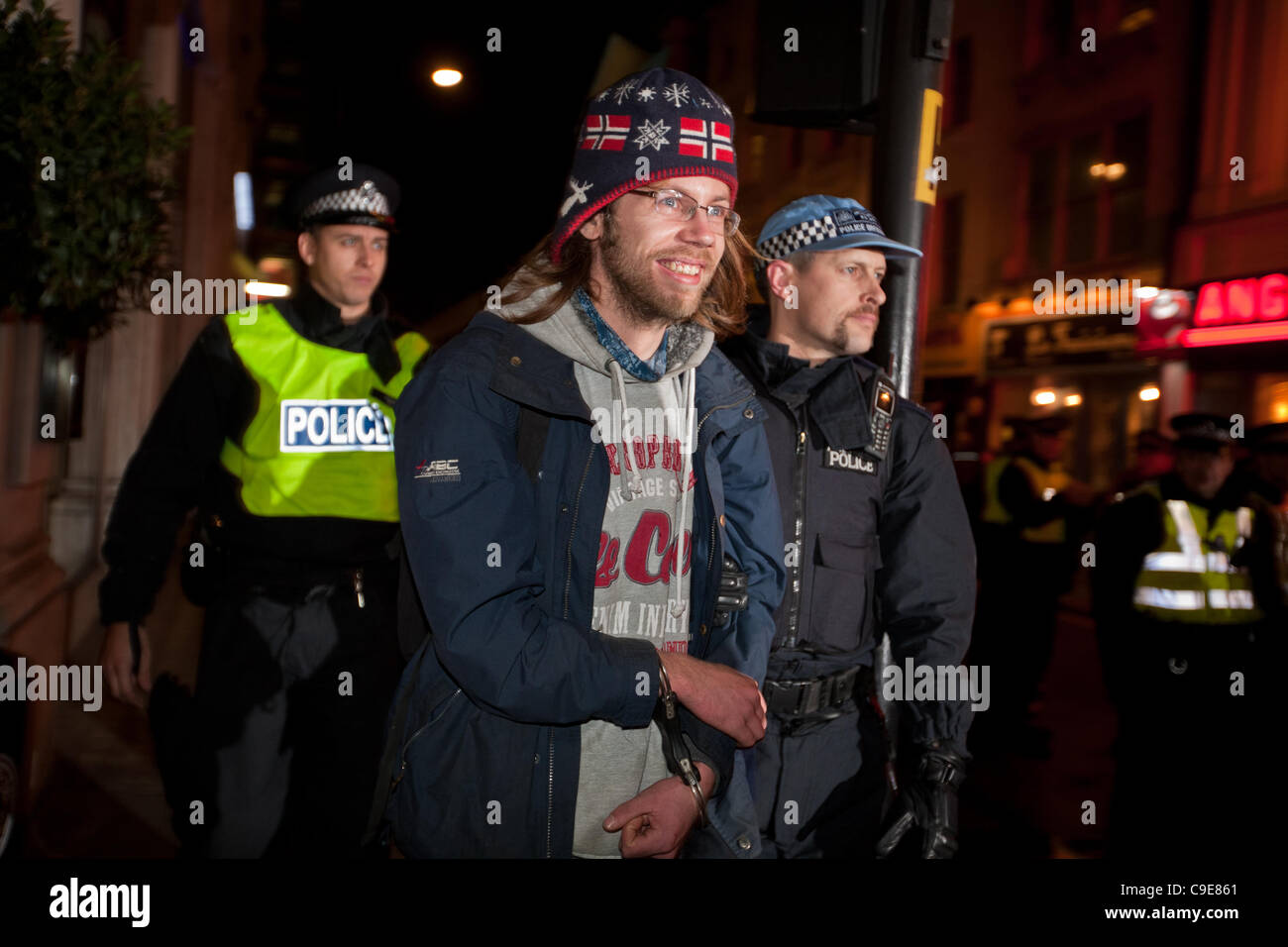 London, UK, 30/11/2011. Protester being led away under arrest after an ...