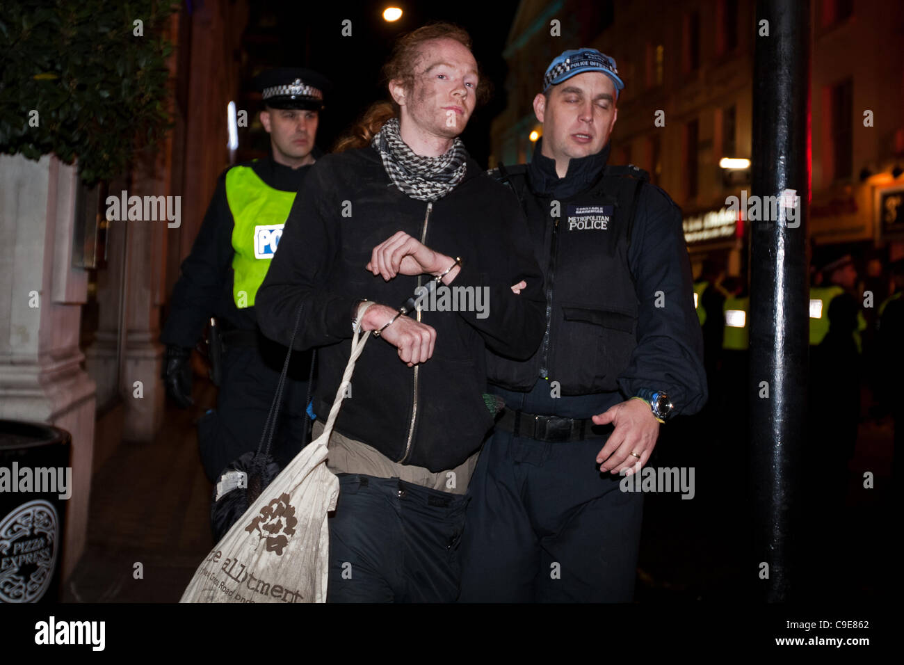 London, UK, 30/11/2011. Protester being led away under arrest after an ...
