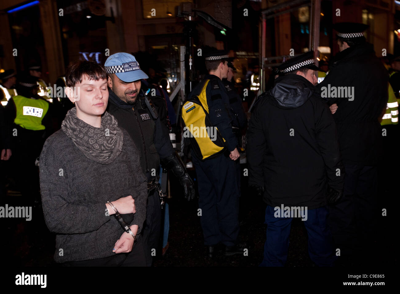 London, UK, 30/11/2011. Protester being led away under arrest after an ...