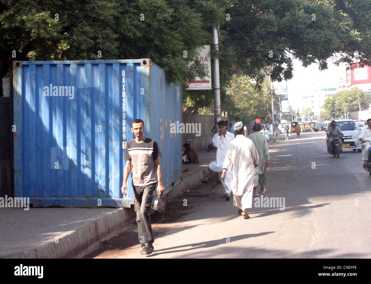 Due to wrongly placed containers karachi pedestrians pass through road ...