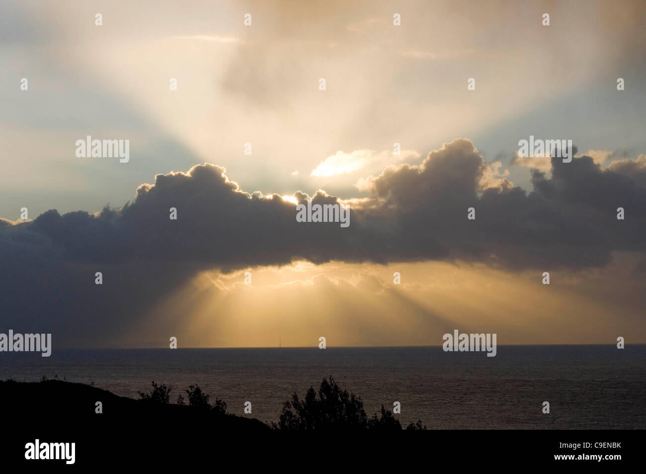 The sun hiding behind the clouds over the North Devon Coastline early ...