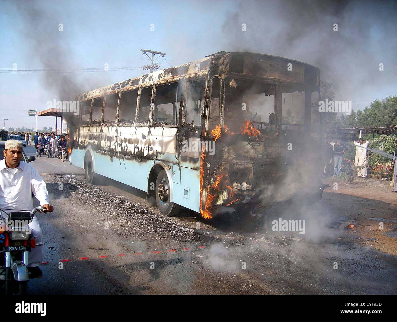 Motorists pass through burning sindh university bus hi-res stock ...